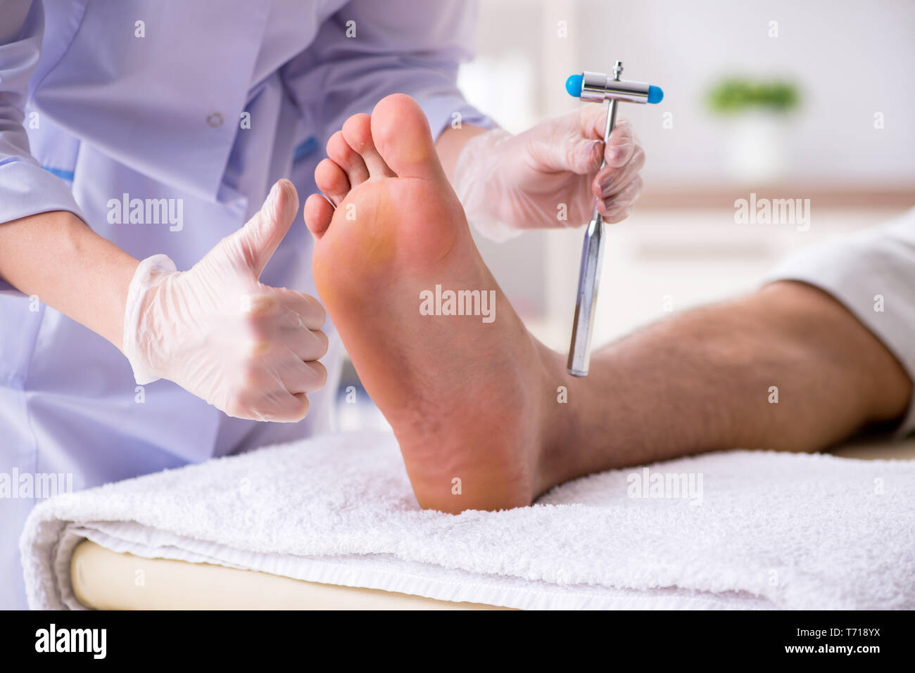 Podiatrist treating feet during procedure Stock Photo - Alamy