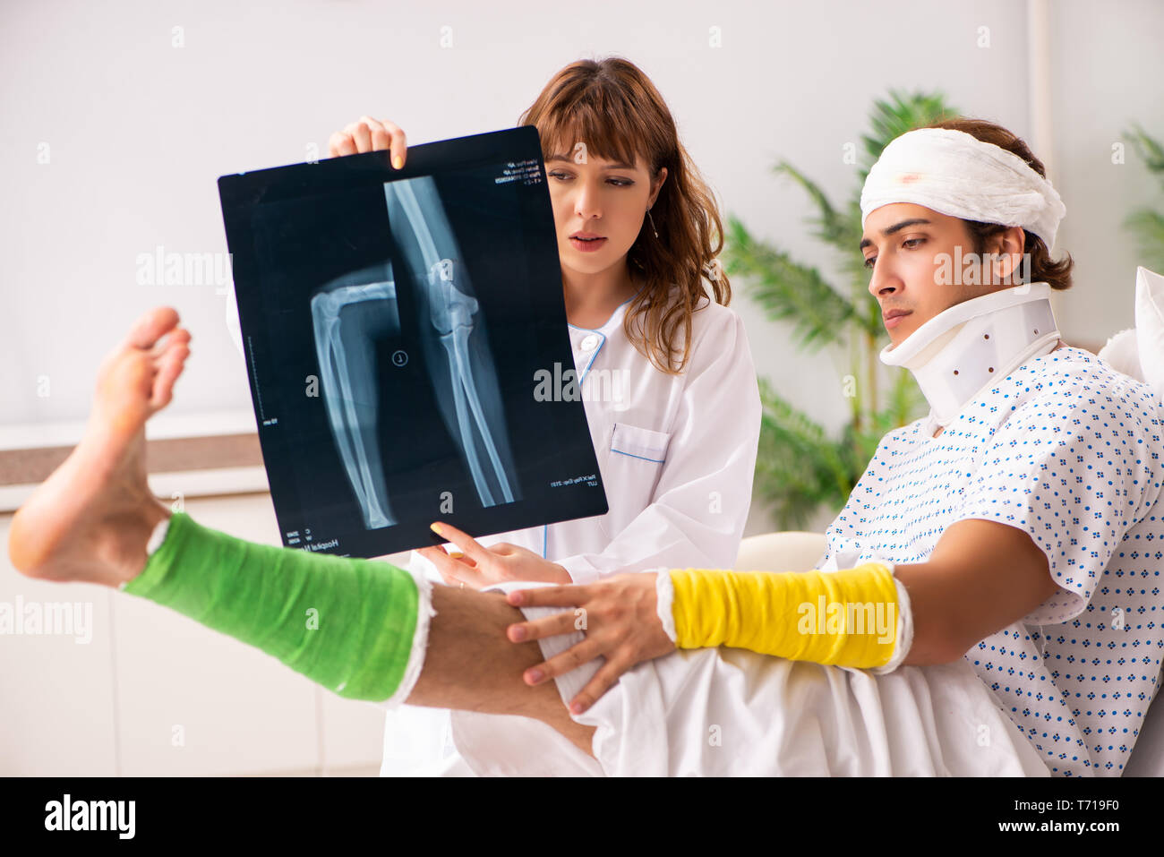 Young doctor examining injured patient Stock Photo - Alamy
