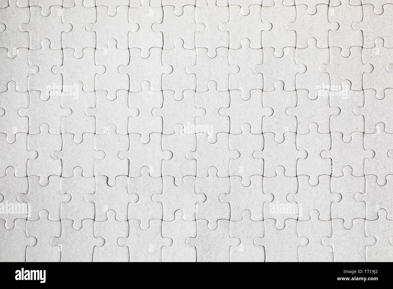 White jigsaw puzzle. White puzzle pieces on color background ...