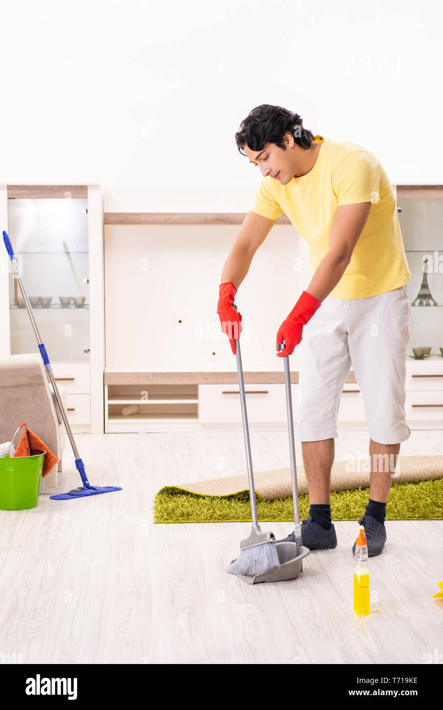 Man sweeping floor dustpan broom hi-res stock photography and images ...