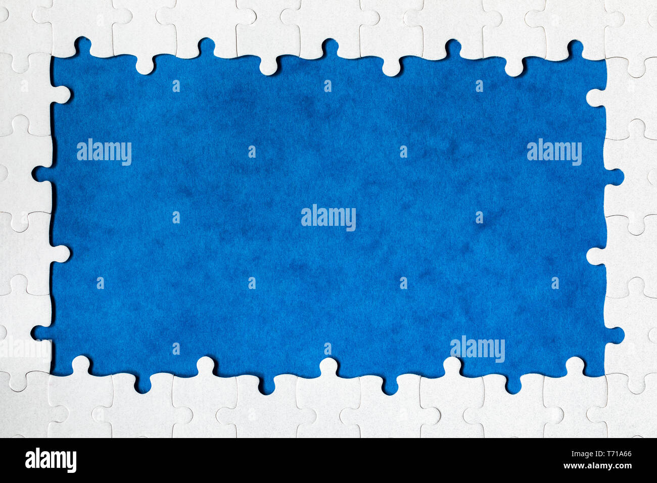 Framing in the form of a rectangle, made of a white jigsaw puzzle ...