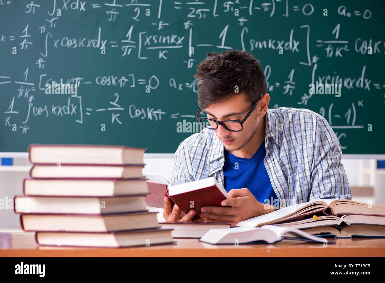 Young male student studying math at school Stock Photo - Alamy