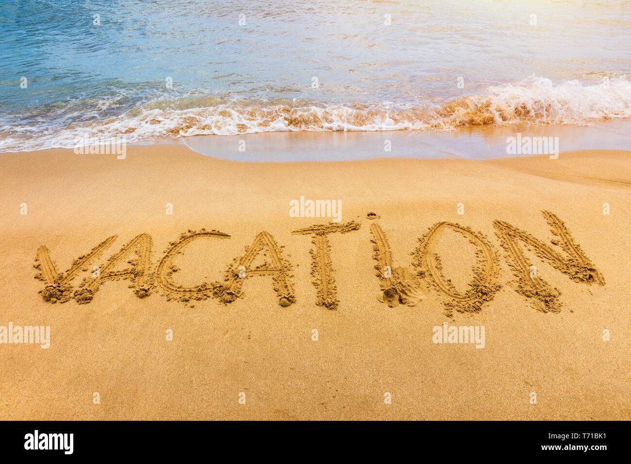 Vacation text on a beach. Vacation written in a sandy tropical beach ...