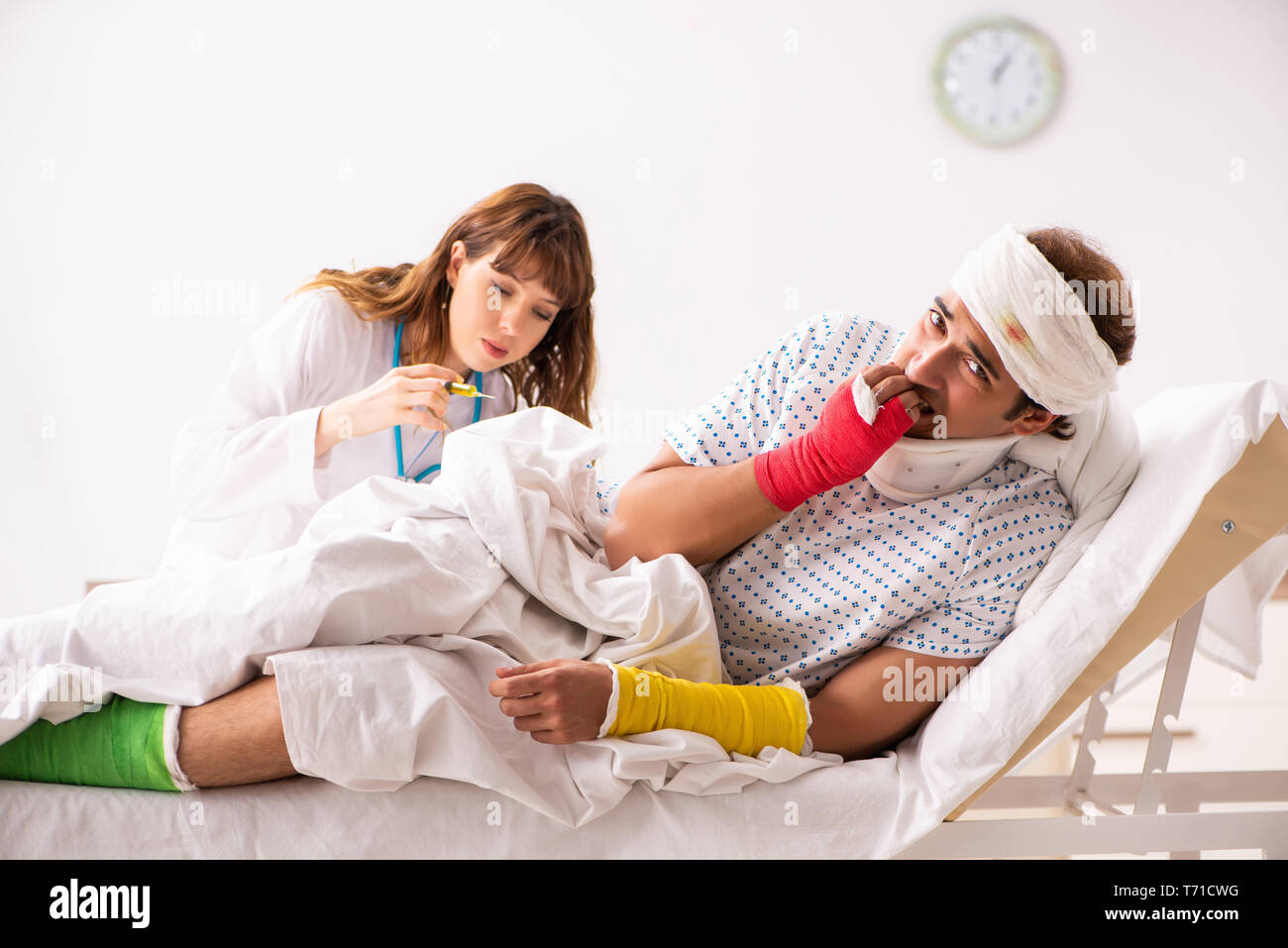 Young doctor examining injured patient Stock Photo - Alamy