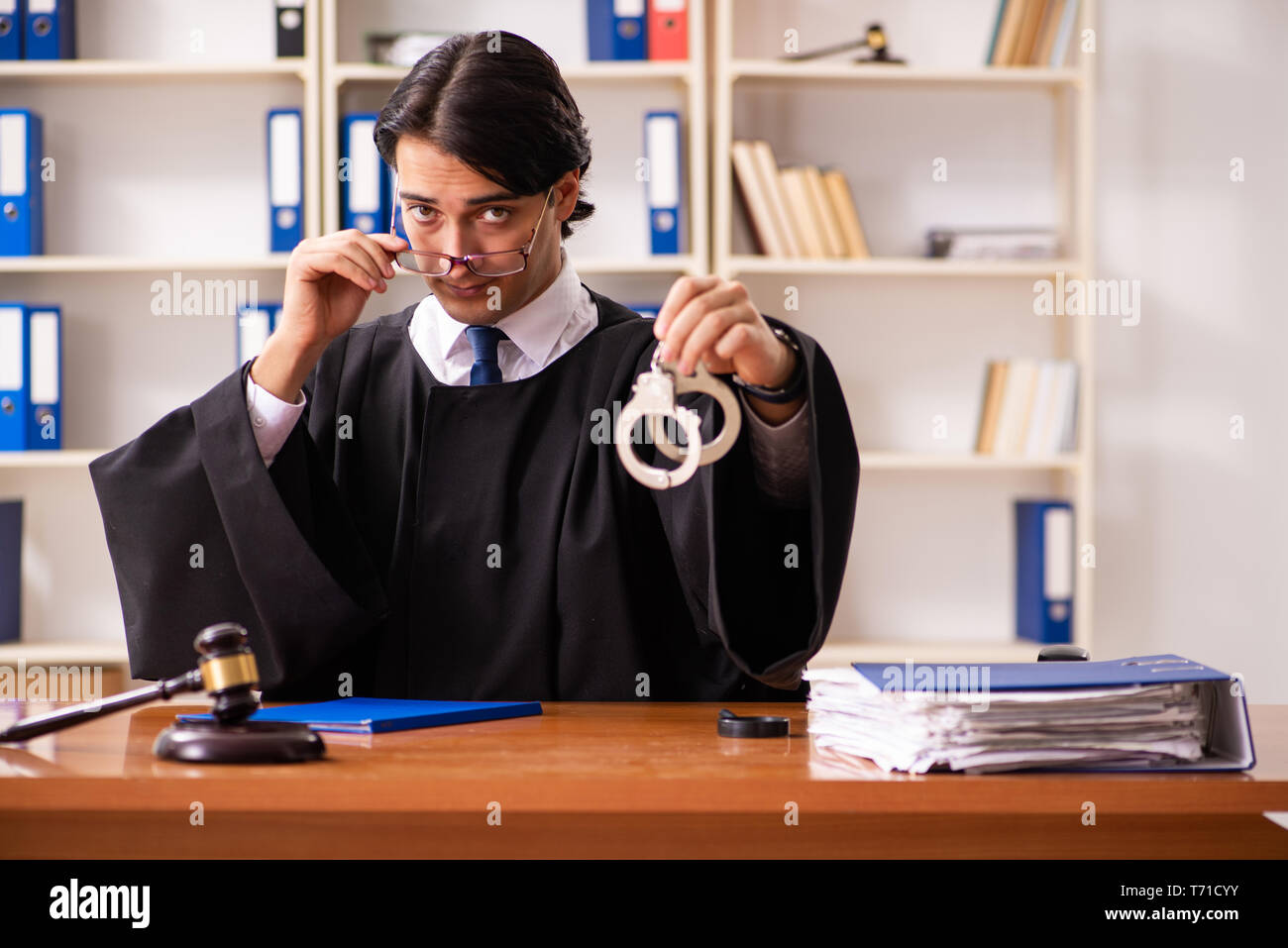 Young handsome judge working in court Stock Photo - Alamy