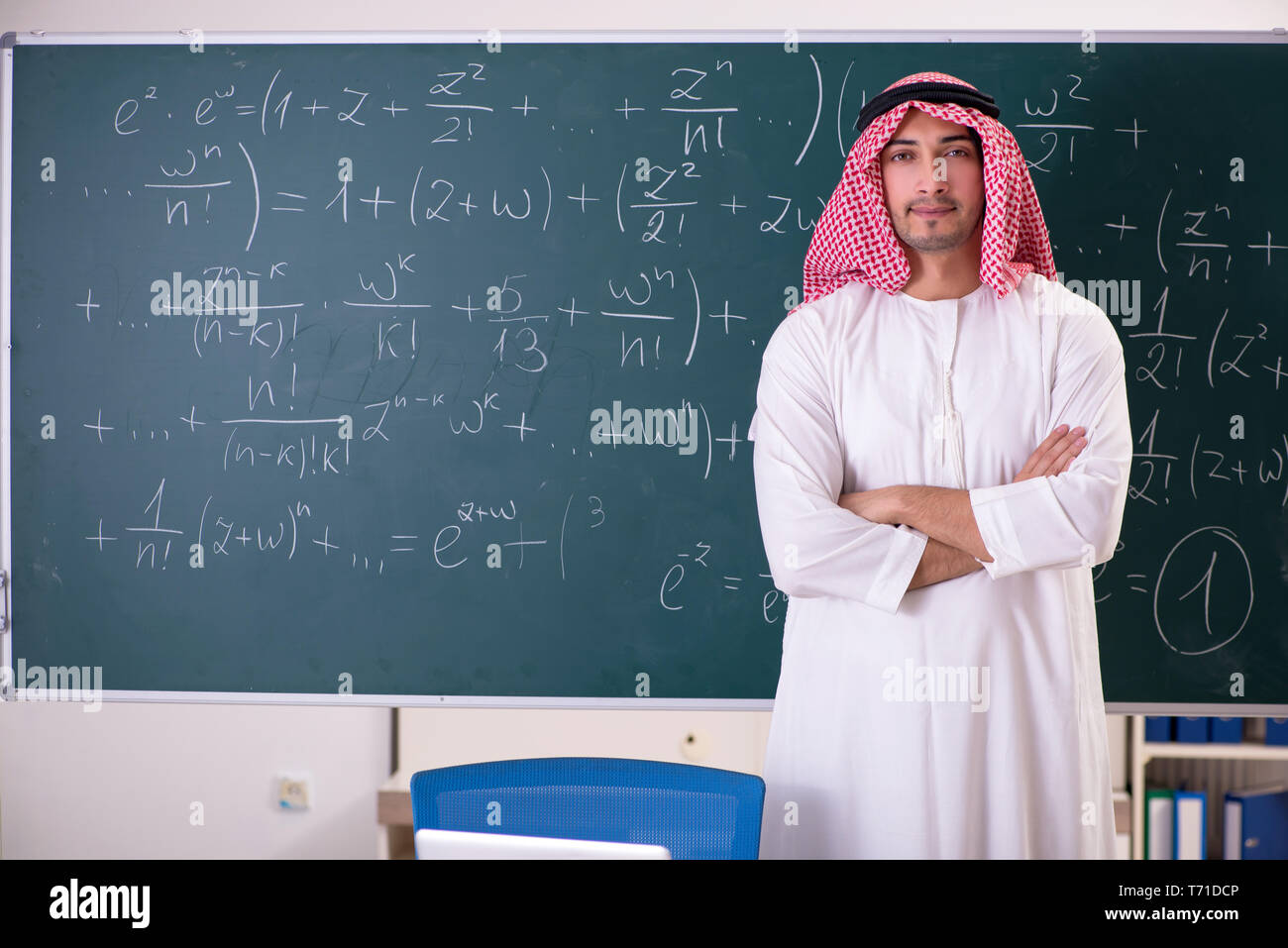 Arab teacher in front of chalkboard Stock Photo - Alamy