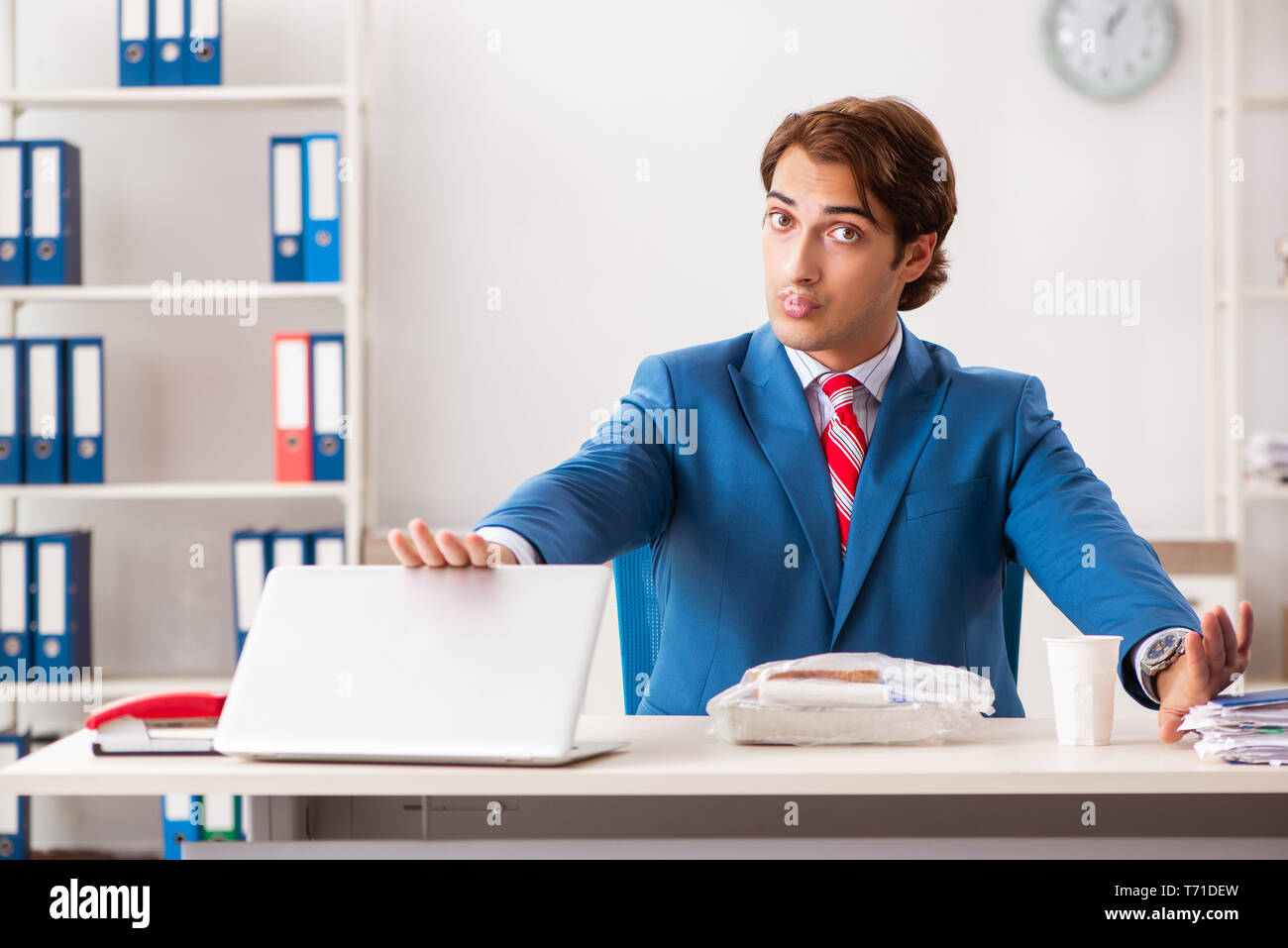 Man having meal at work during break Stock Photo - Alamy
