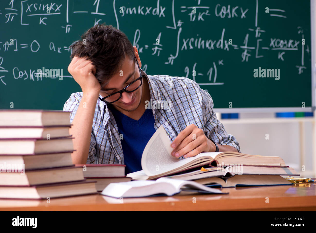 Young male student studying math at school Stock Photo - Alamy
