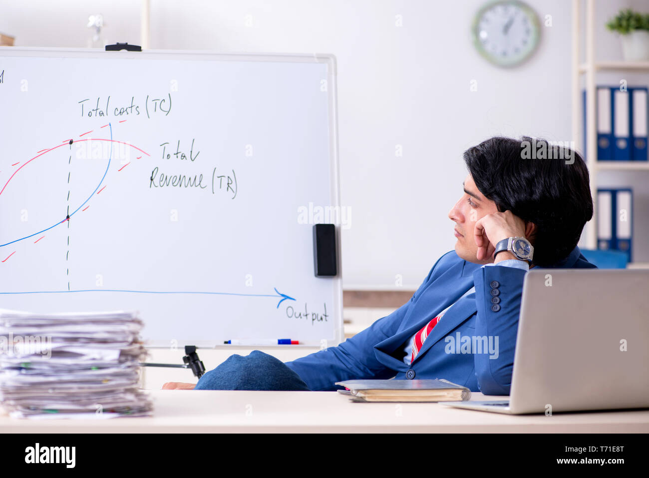 Busy businessman explaining business charts Stock Photo - Alamy