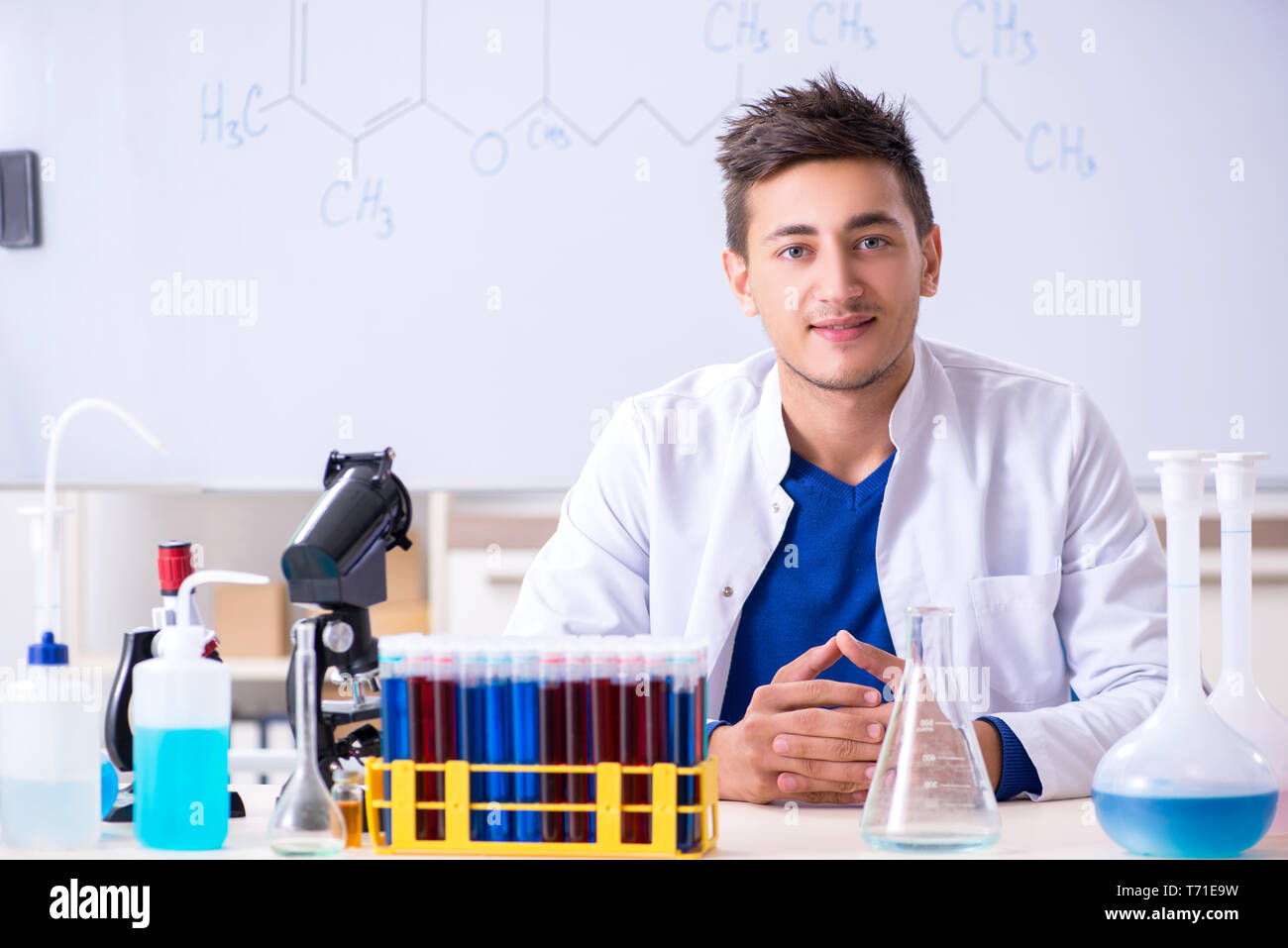 Happy young chemist mixing hi-res stock photography and images - Alamy