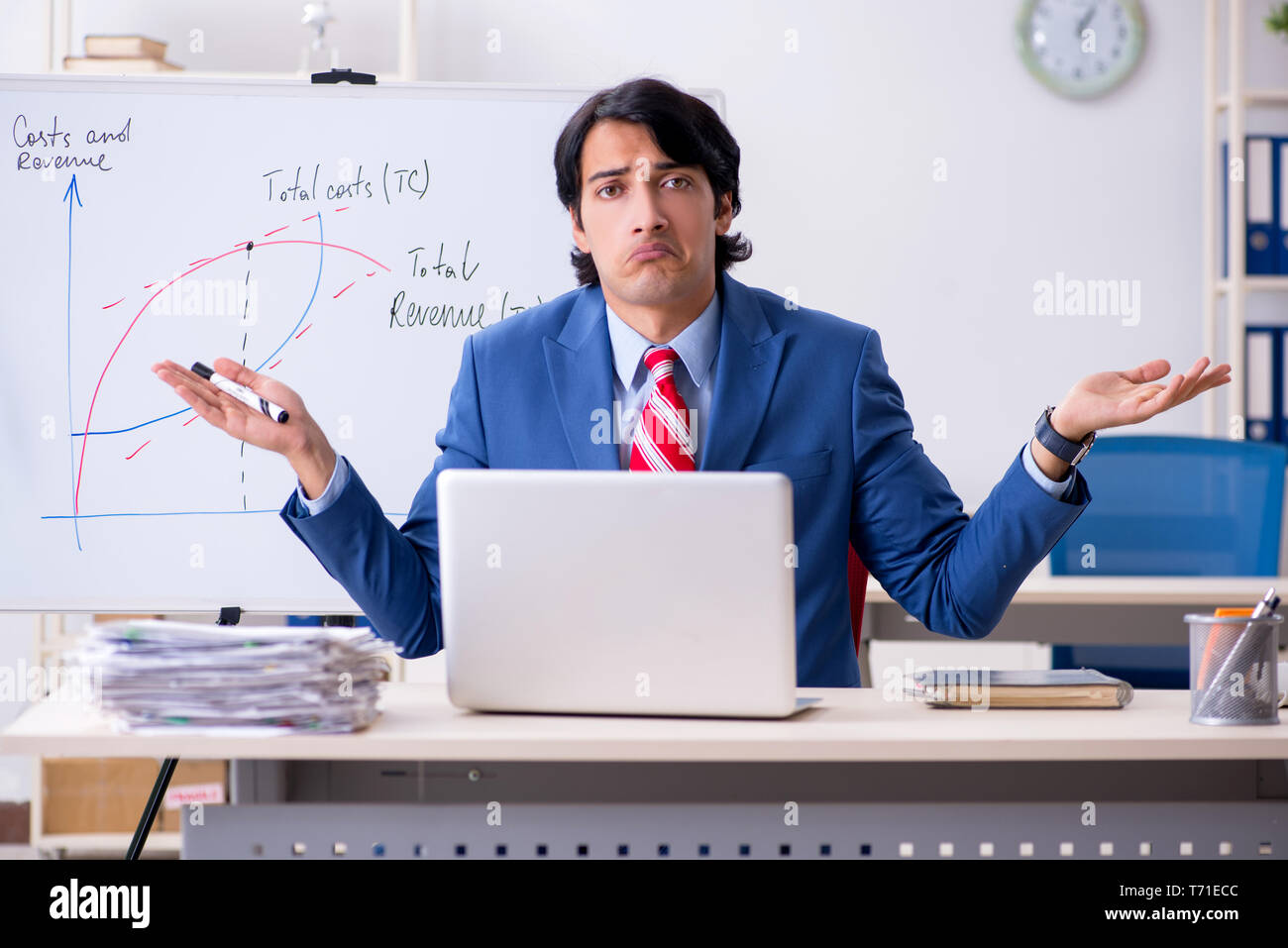 Busy businessman explaining business charts Stock Photo - Alamy