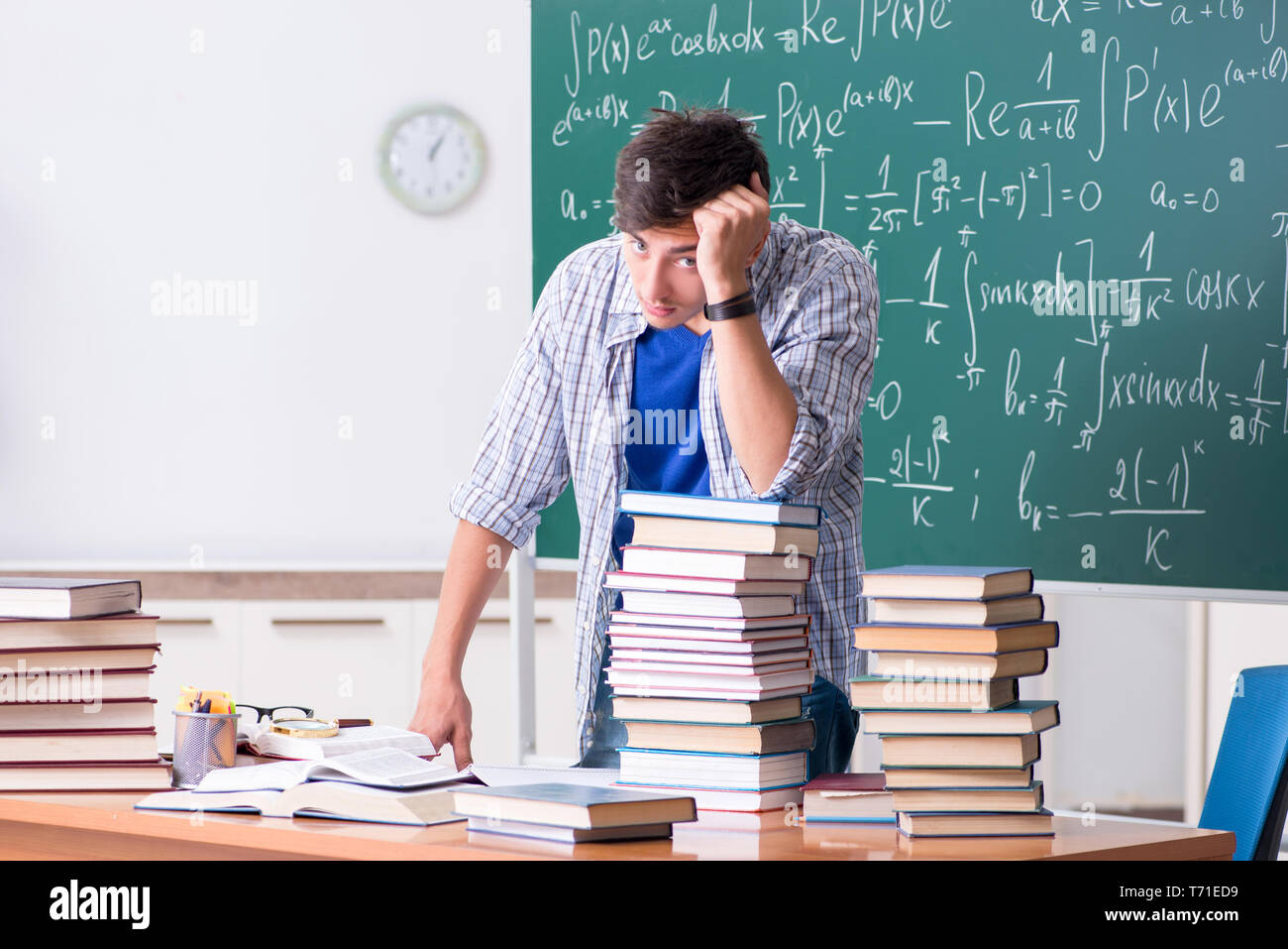 Young male student studying math at school Stock Photo - Alamy