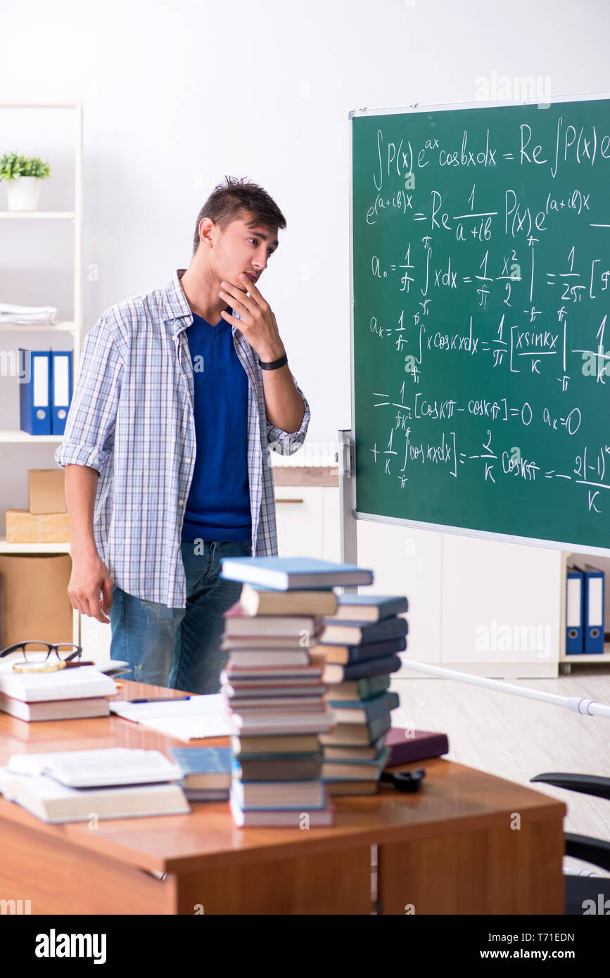 Young male student studying math at school Stock Photo - Alamy