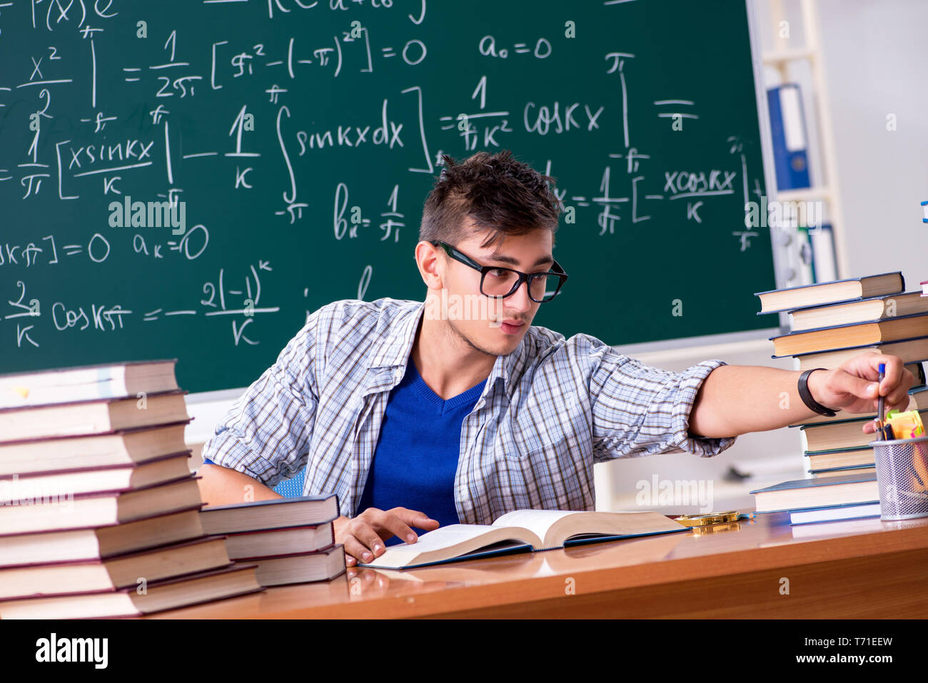 Young male student studying math at school Stock Photo - Alamy