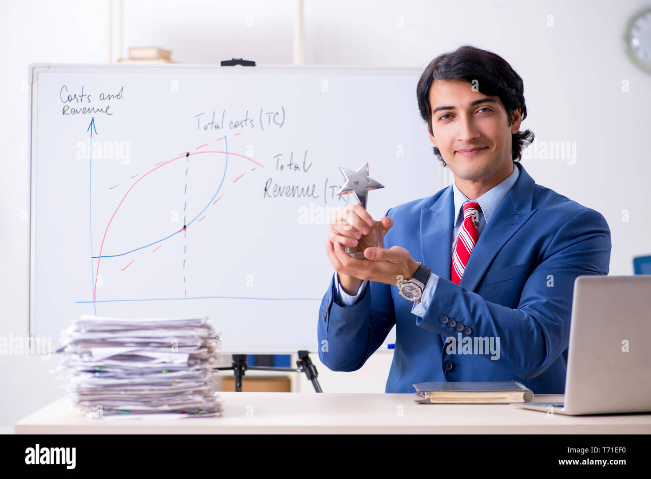 Busy businessman explaining business charts Stock Photo - Alamy