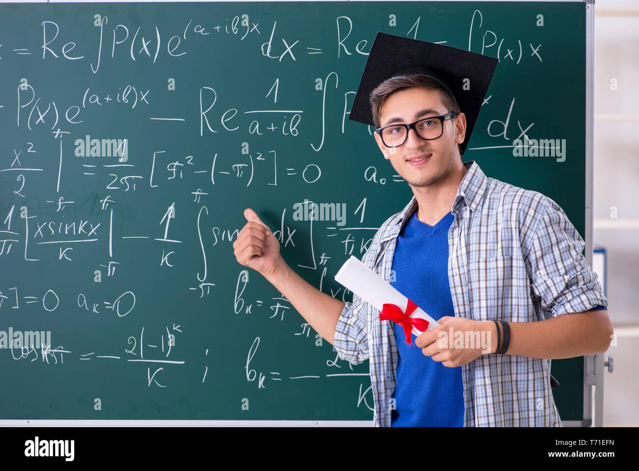 Young male student studying math at school Stock Photo - Alamy