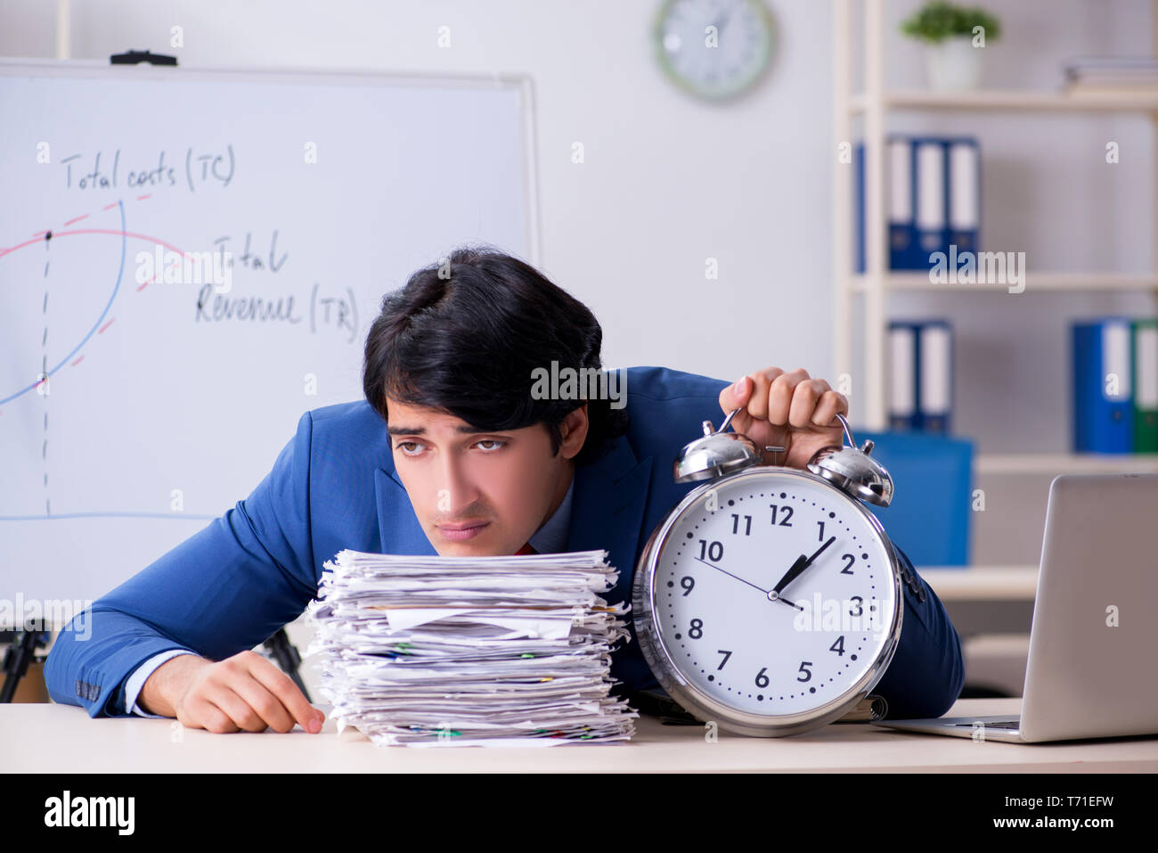 Busy businessman explaining business charts Stock Photo - Alamy