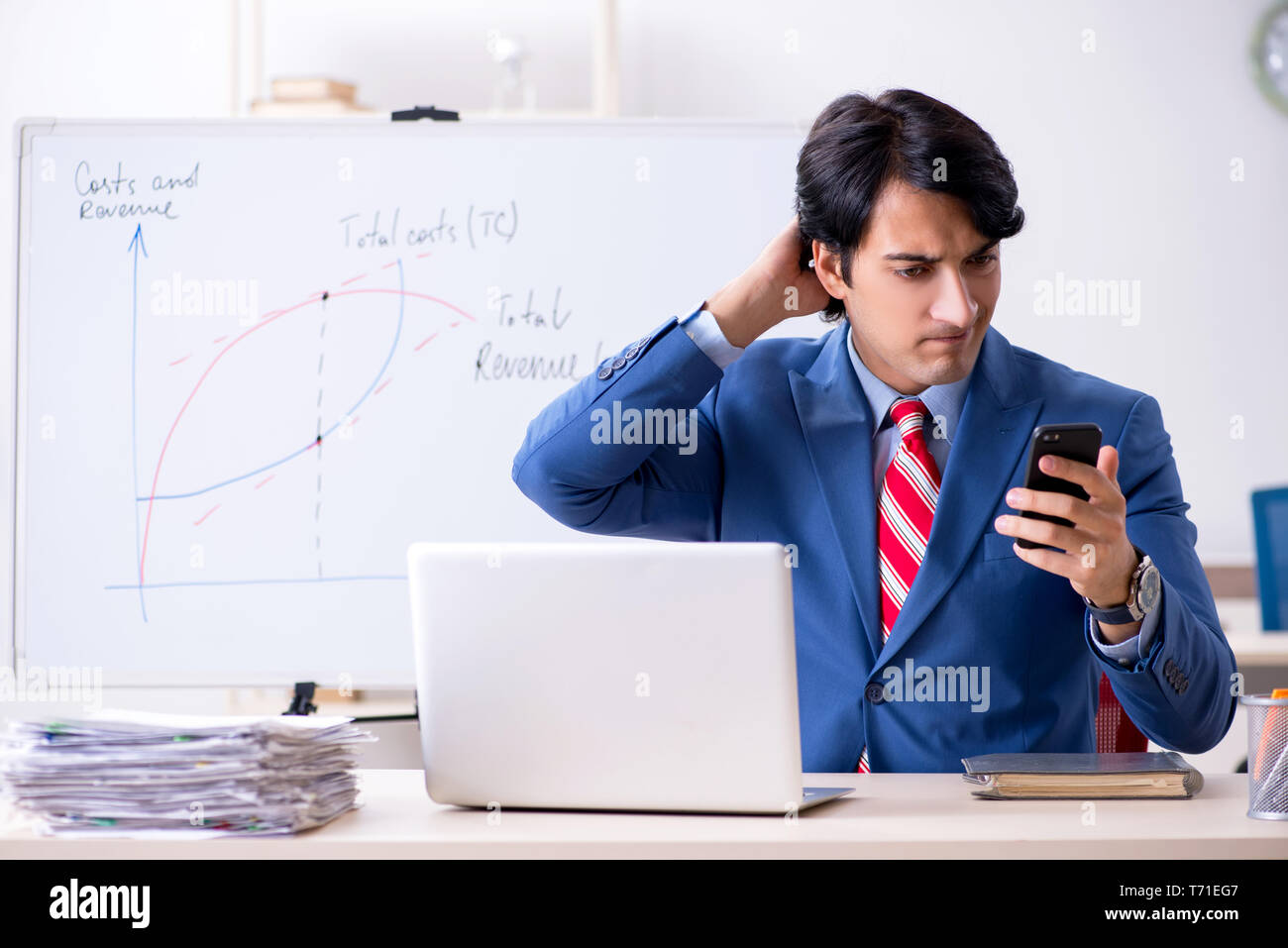 Busy businessman explaining business charts Stock Photo - Alamy