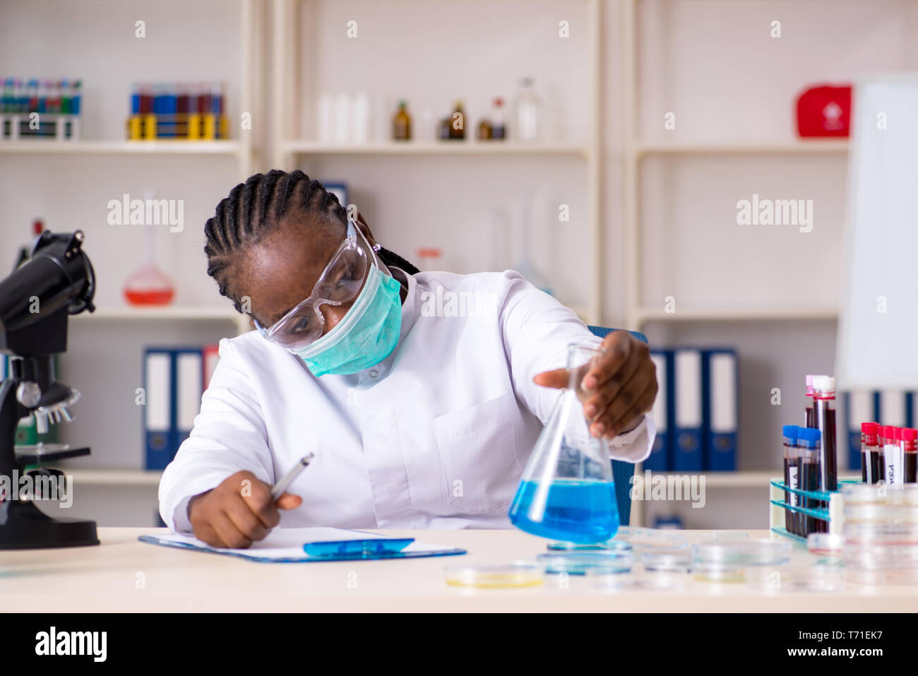 Black woman afro pouring hi-res stock photography and images - Alamy
