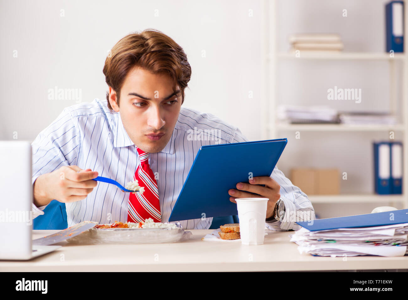 Man having meal at work during break Stock Photo - Alamy