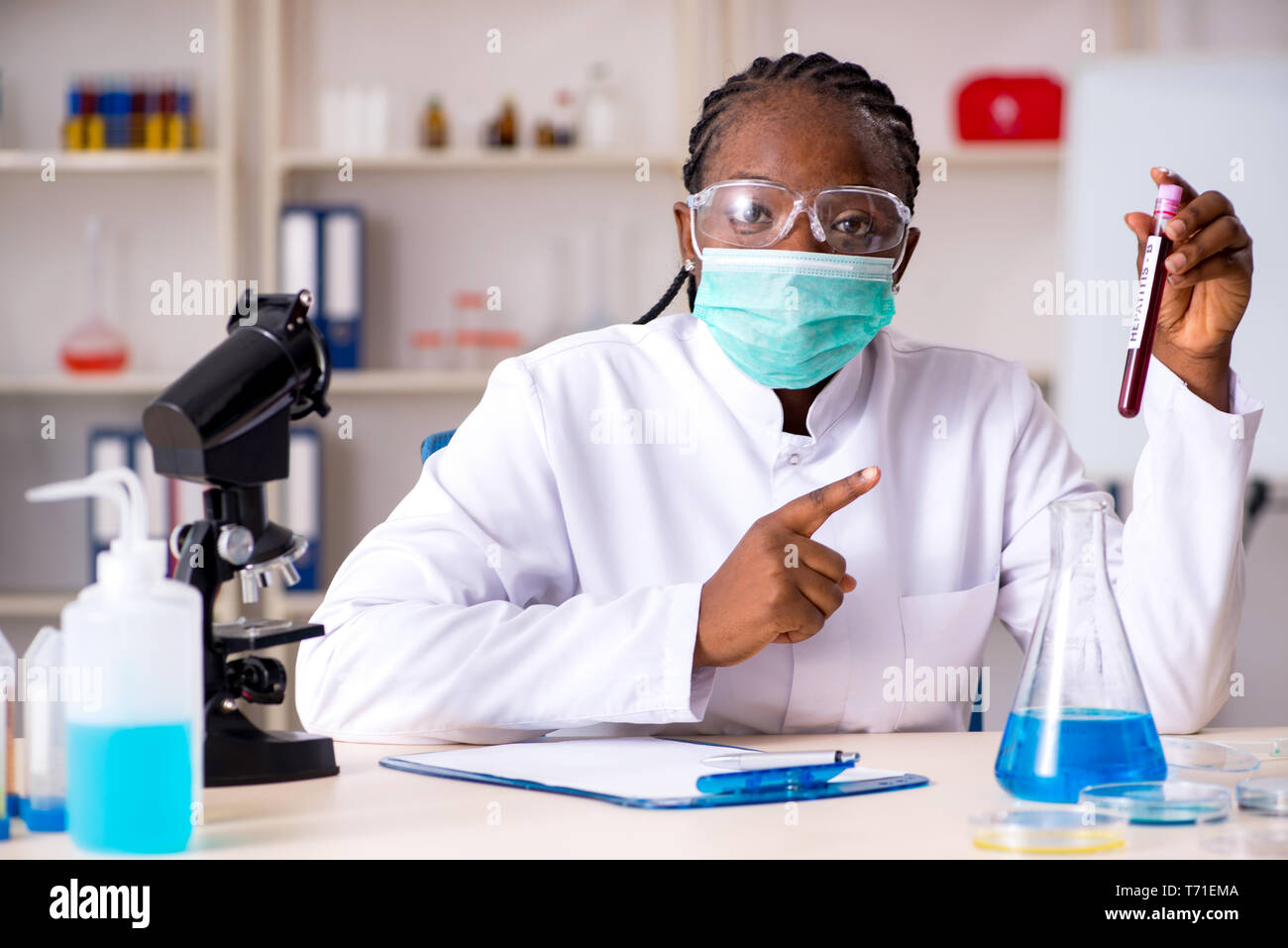 Young black chemist working in the lab Stock Photo - Alamy