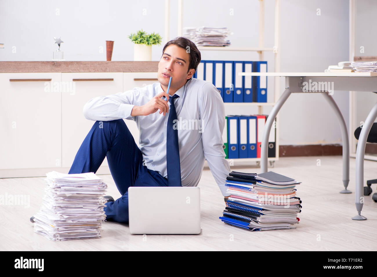Extremely busy employee working in the office Stock Photo - Alamy