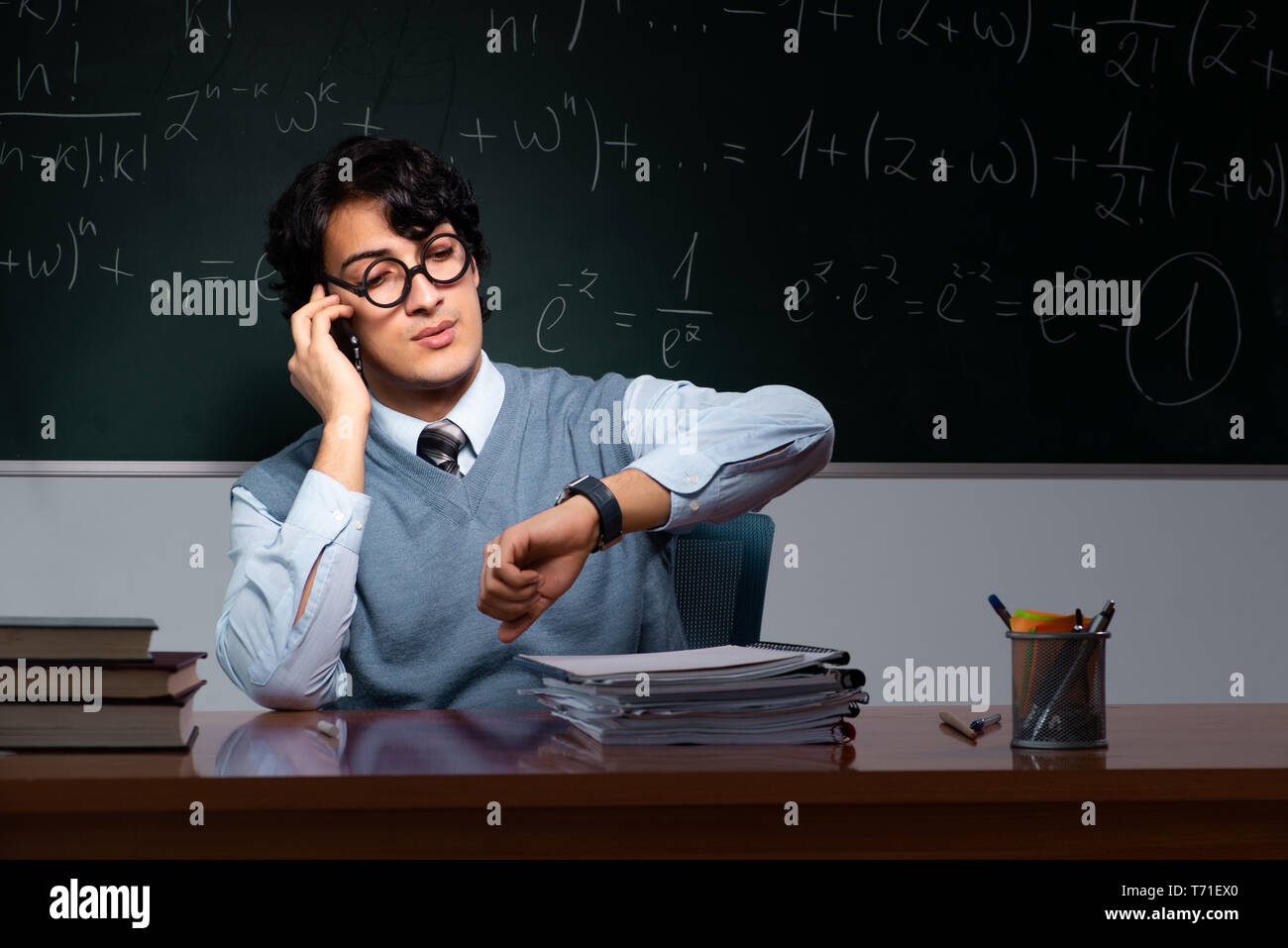 Young math teacher in front of chalkboard Stock Photo - Alamy