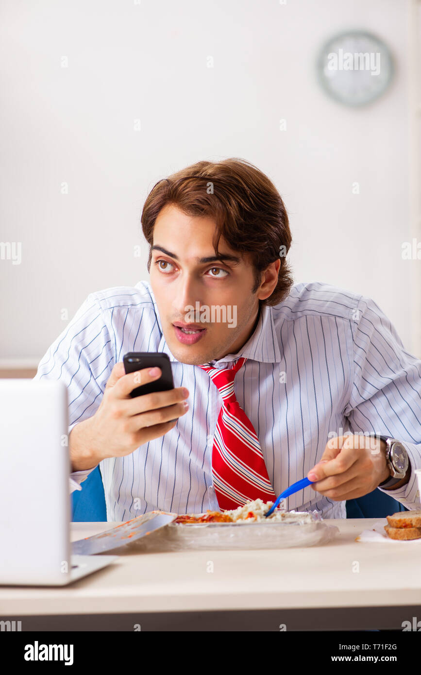 Man having meal at work during break Stock Photo - Alamy