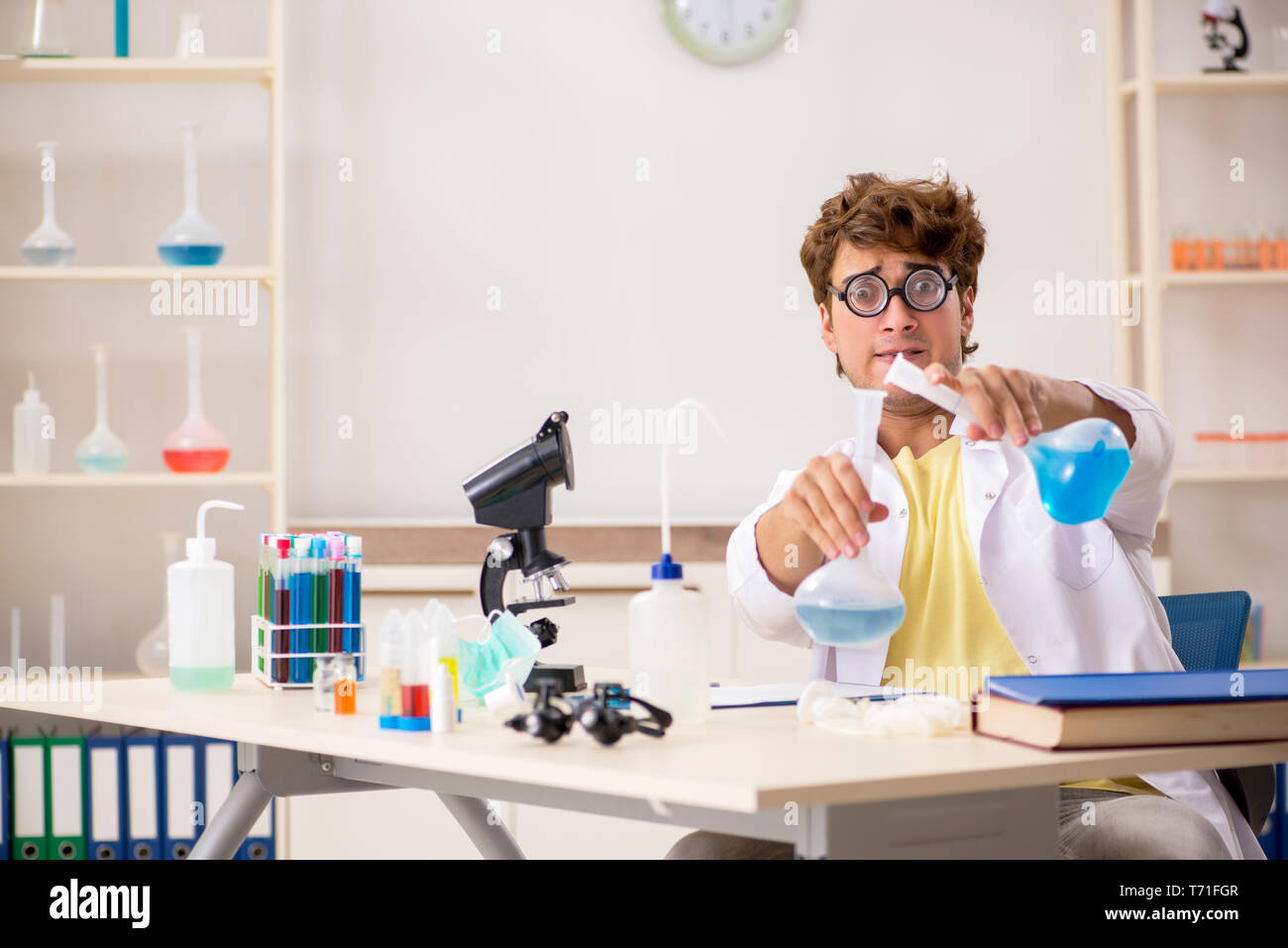 Funny crazy chemist doing experiments and tests Stock Photo - Alamy
