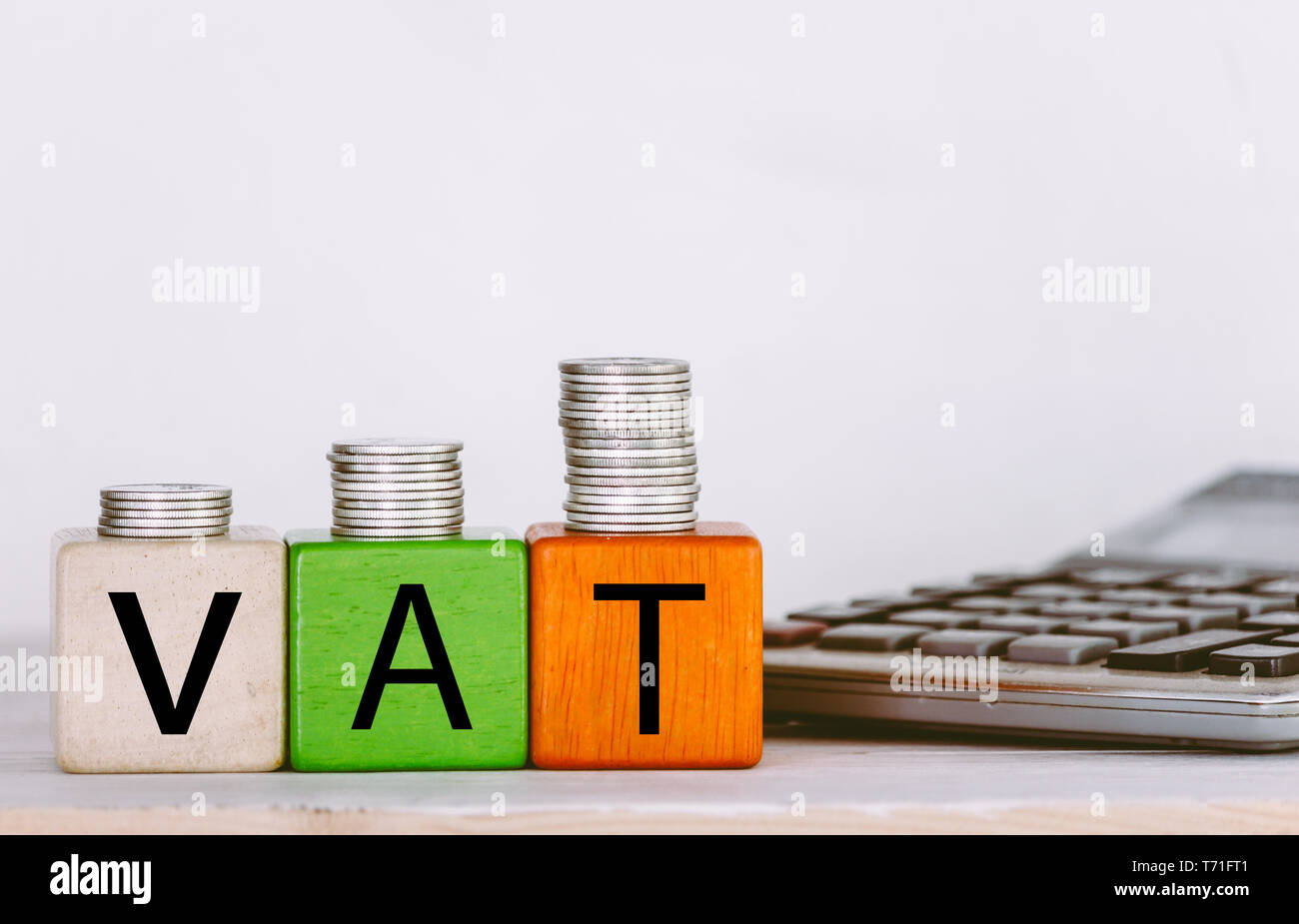 VAT Concept with wooden block with stacked coins Stock Photo - Alamy