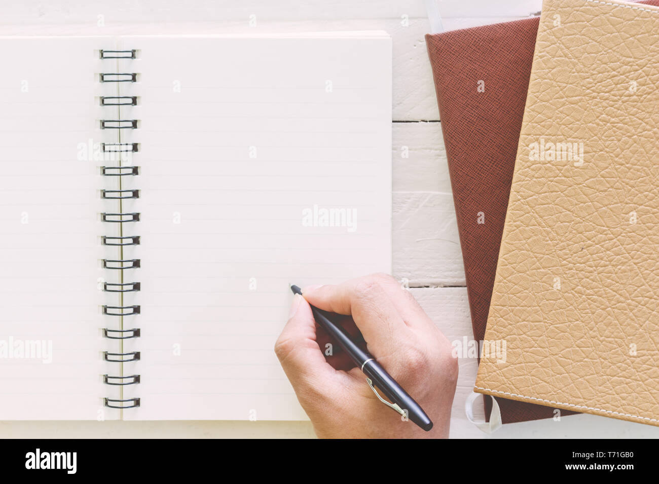 Open blank notepad with empty white pages on wooden table Stock Photo ...