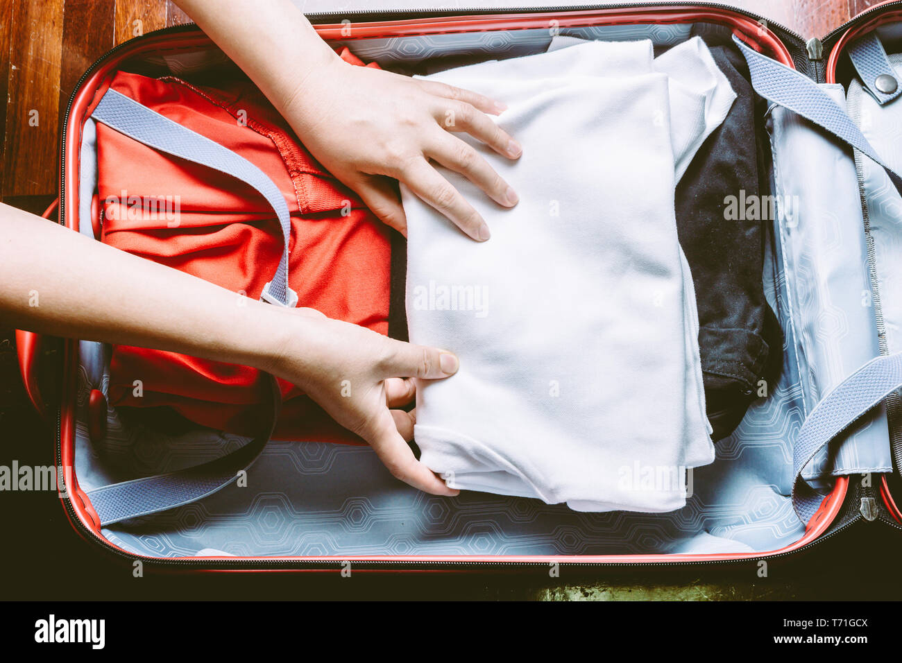 Woman's hands are packing a luggage Stock Photo - Alamy