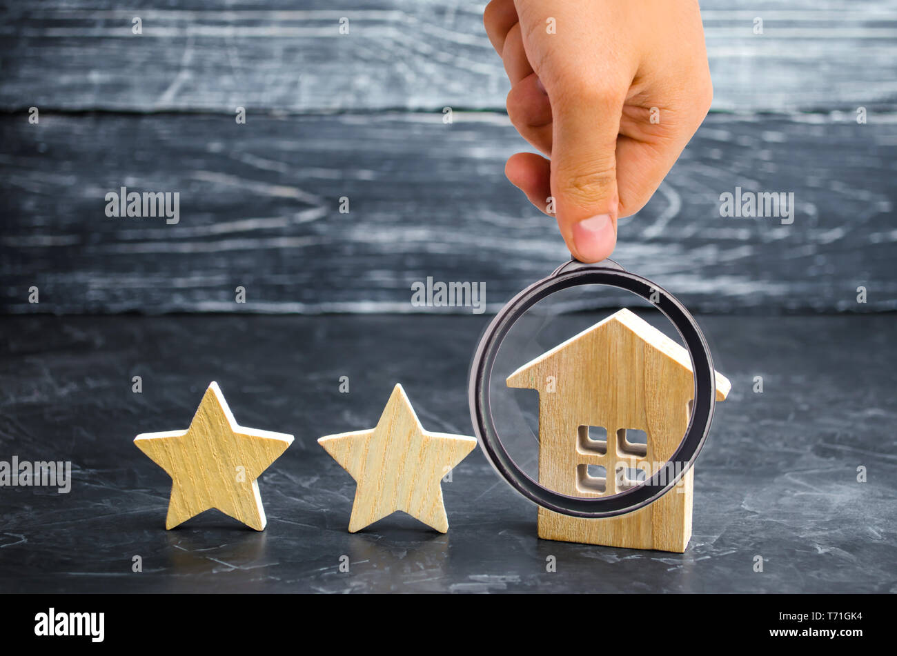 Two wooden stars and a house. Two star hotel or restaurant. Review of ...