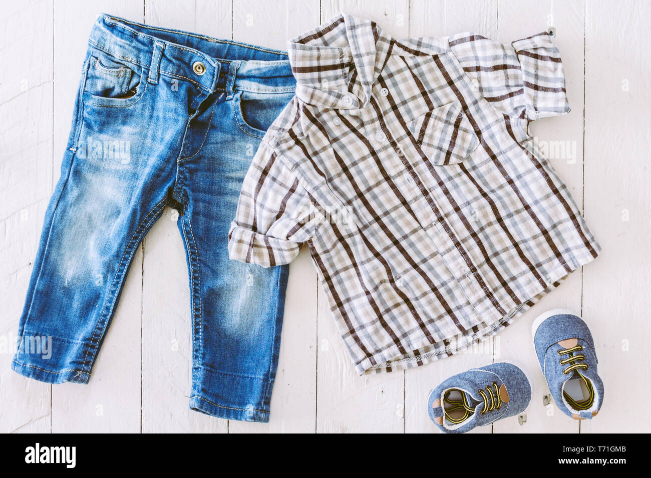 Children clothing on wooden background Stock Photo - Alamy
