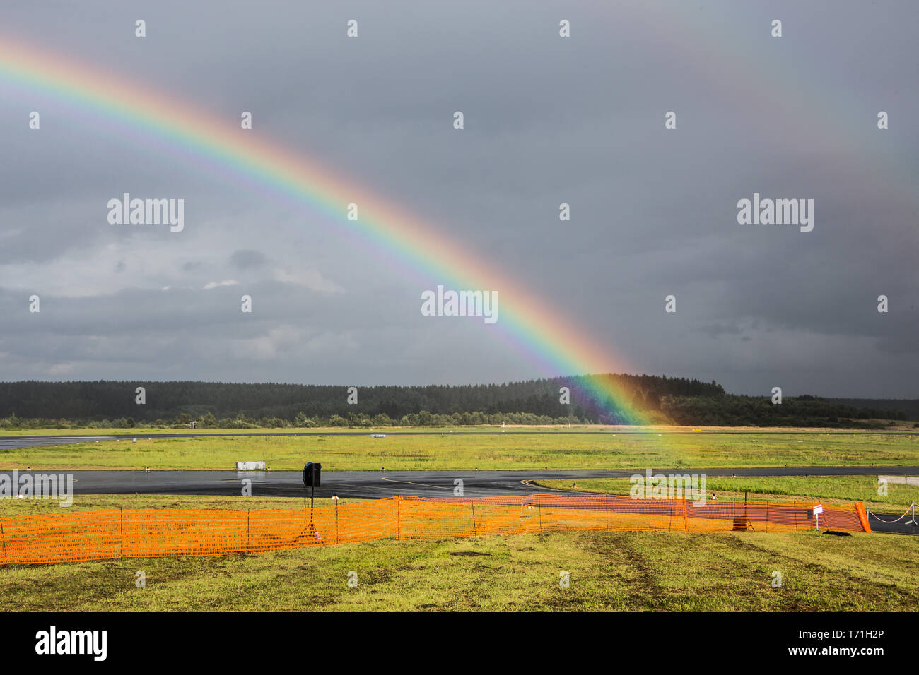Rainbow over airfield Stock Photo - Alamy