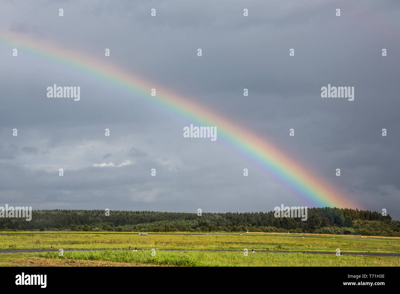 Rainbow over airfield Stock Photo - Alamy