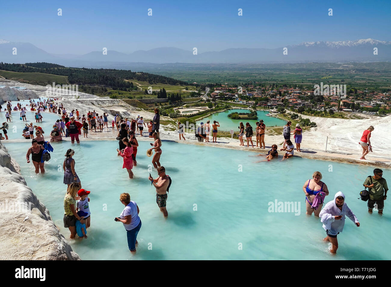 Tourists at Pamukkale hot springs and travertine pools, UNESCO world ...