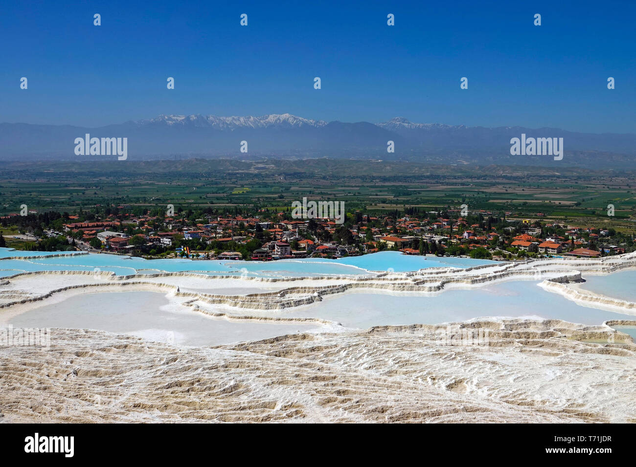 Tourists at Pamukkale hot springs and travertine pools, UNESCO world ...