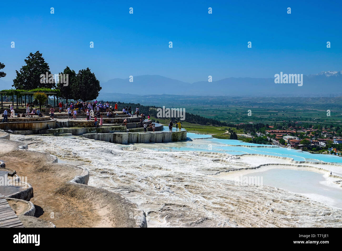 Tourists at Pamukkale hot springs and travertine pools, UNESCO world ...