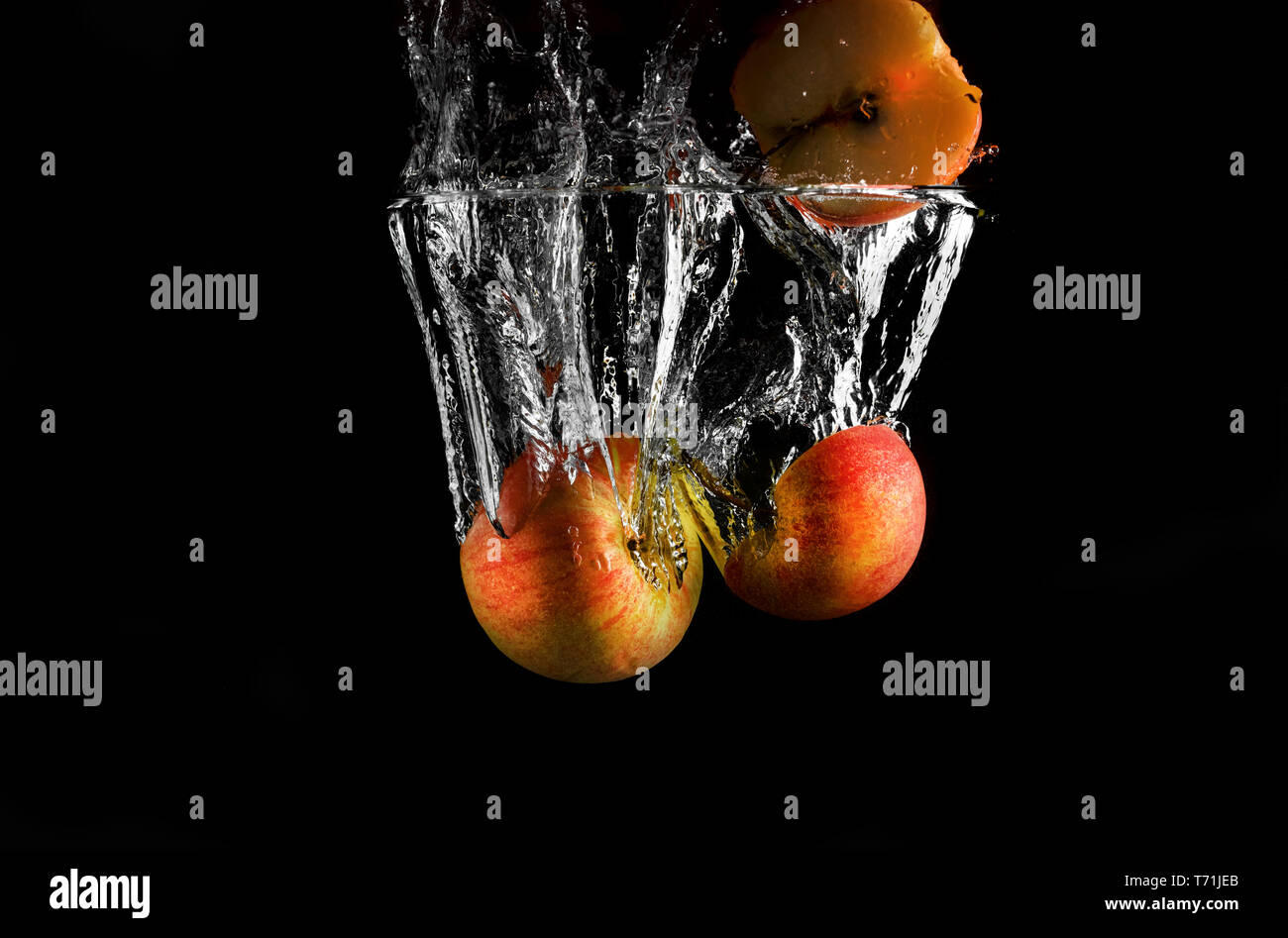 Apples falling in water Stock Photo - Alamy
