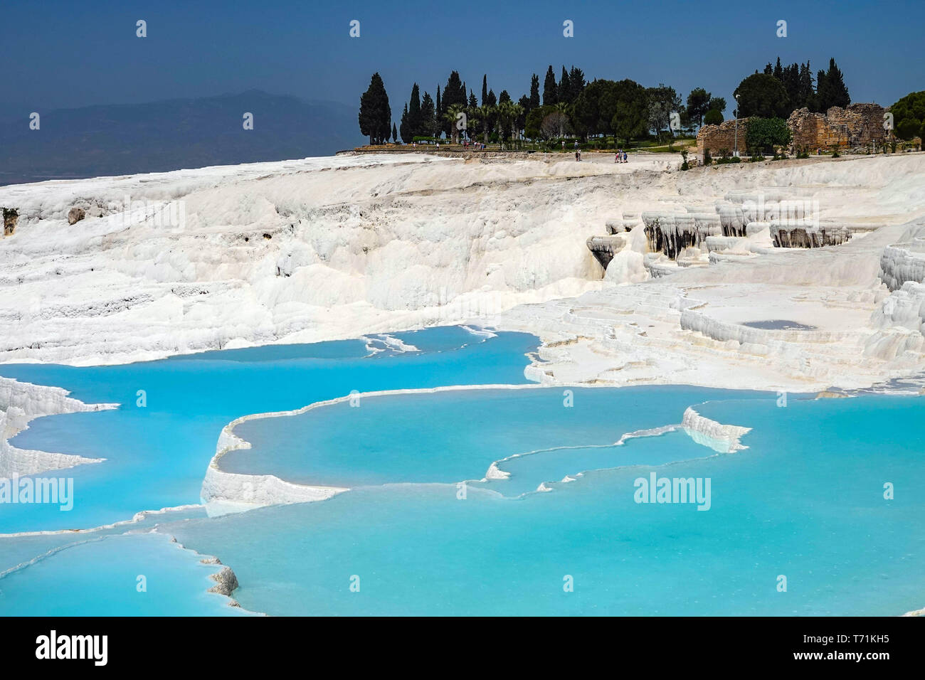 Tourists at Pamukkale hot springs and travertine pools, UNESCO world ...