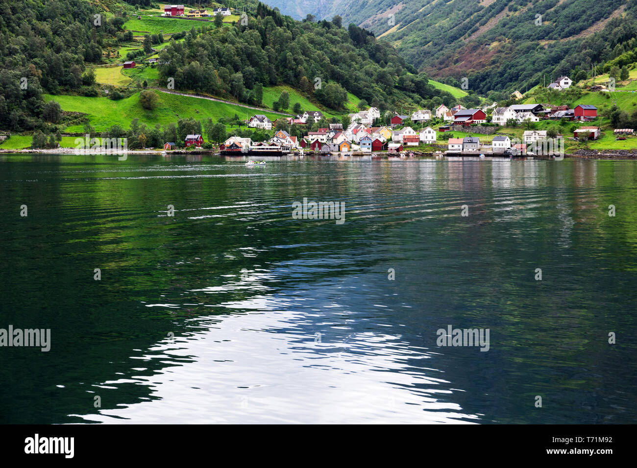 Reflection of a small town in norwegian fiord Stock Photo - Alamy