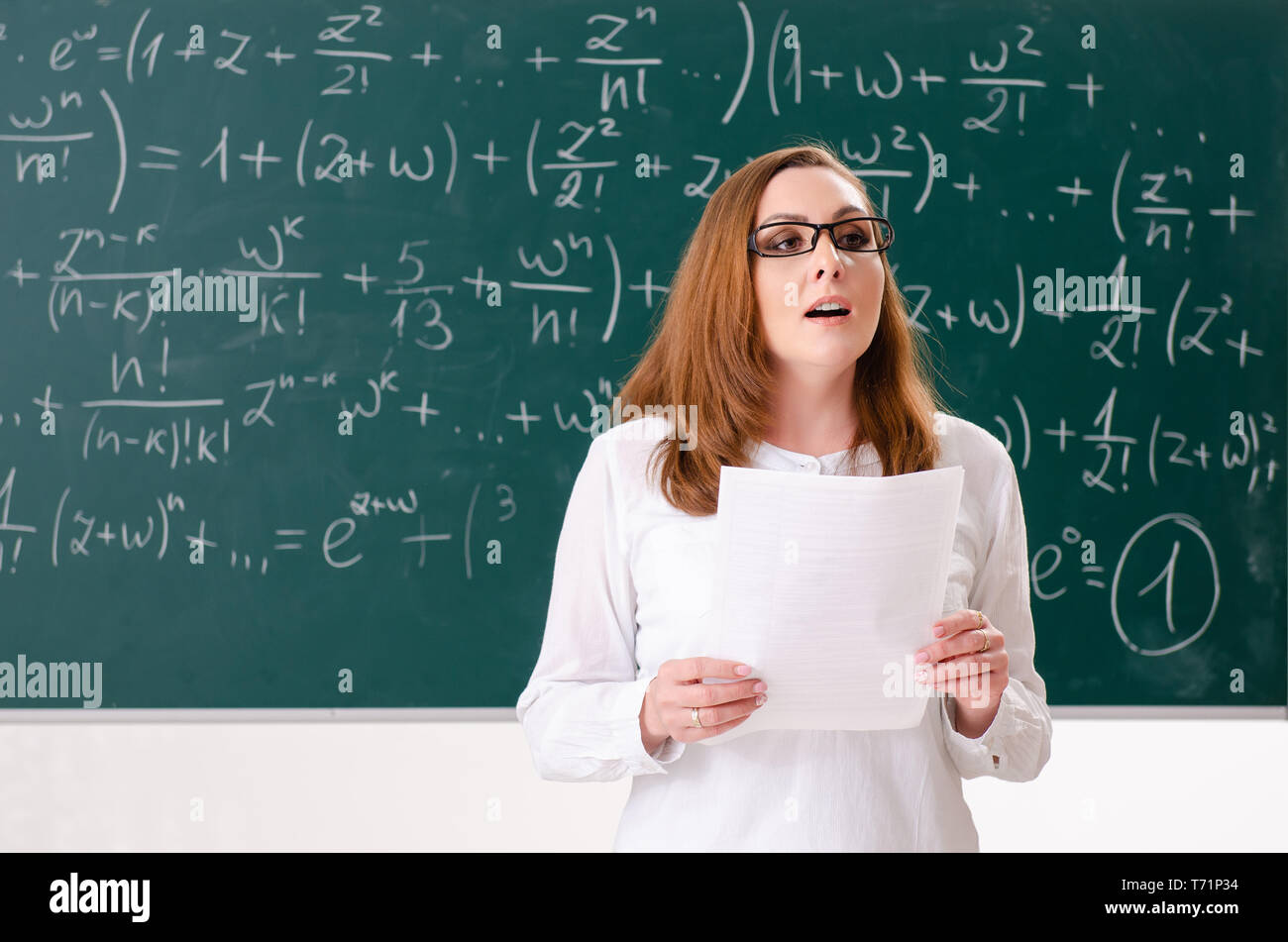 Female math teacher in the classroom Stock Photo - Alamy