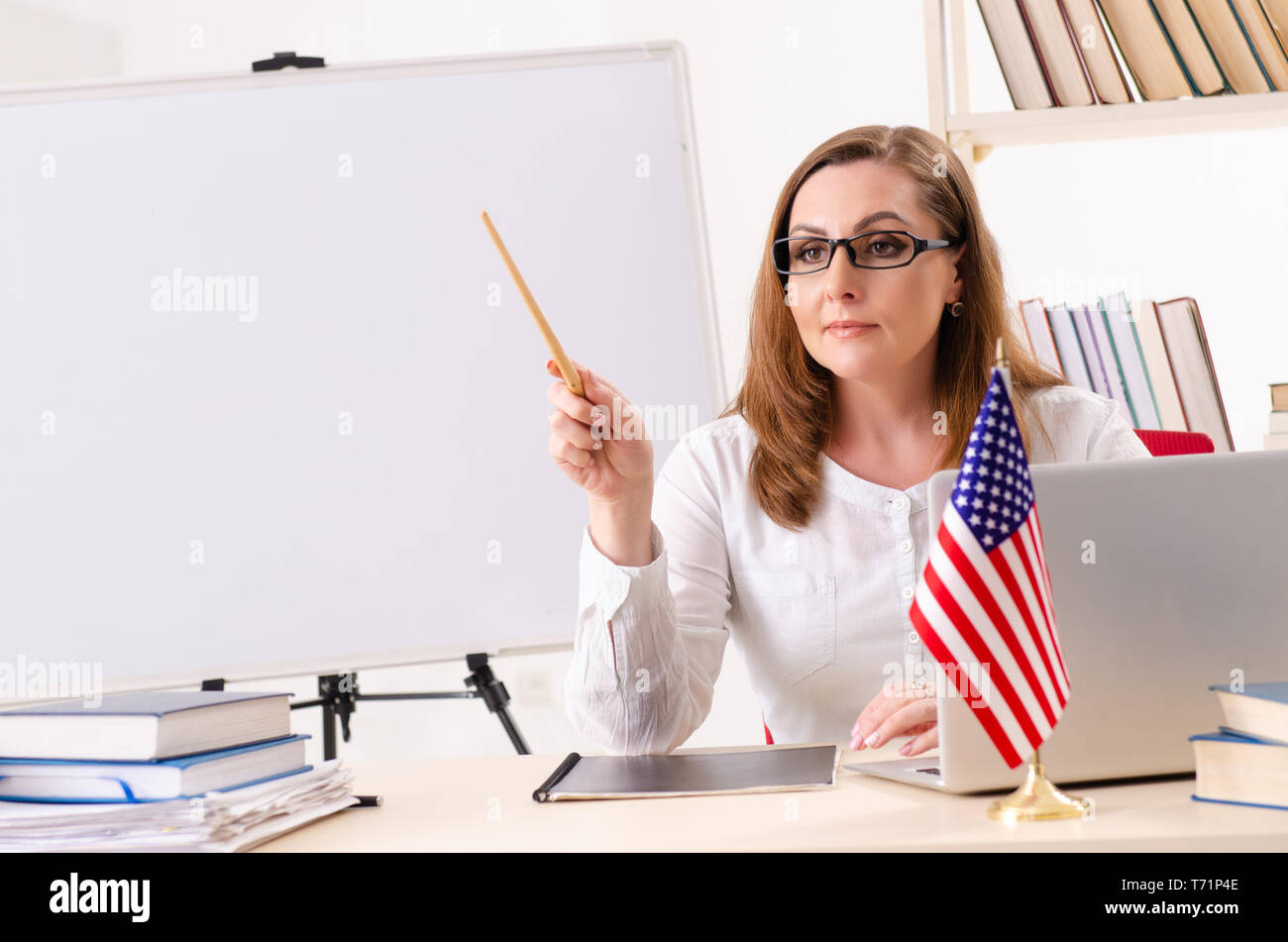 Female english teacher in the classroom Stock Photo - Alamy