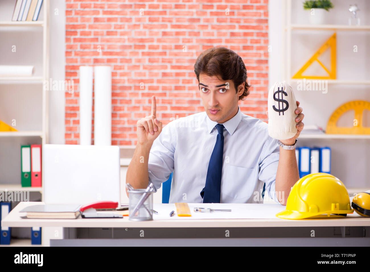 Construction supervisor working on blueprints Stock Photo - Alamy