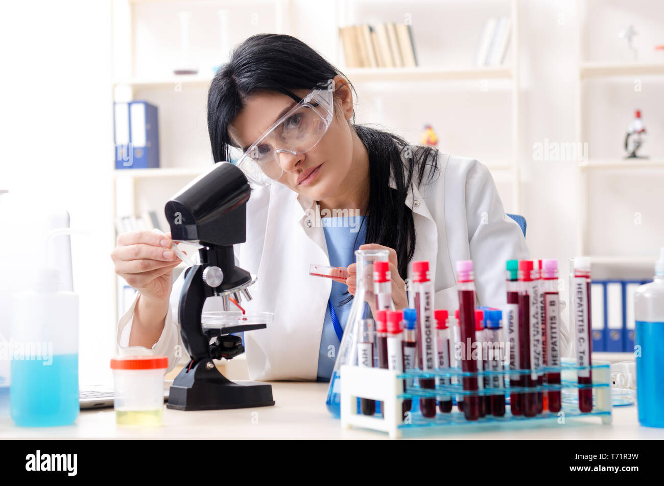 Female chemist working at the lab Stock Photo - Alamy