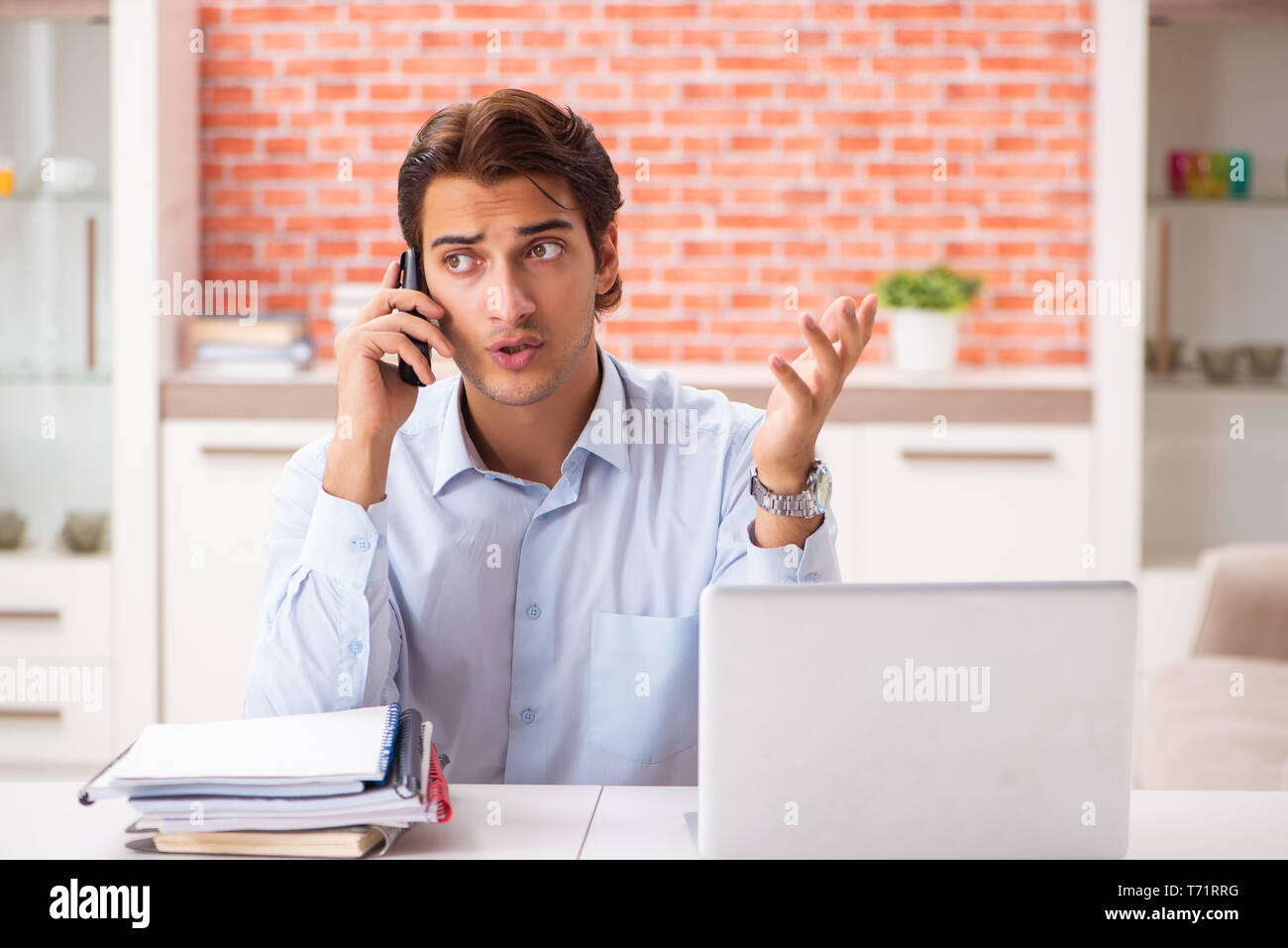 Young handsome employee working in the office Stock Photo - Alamy