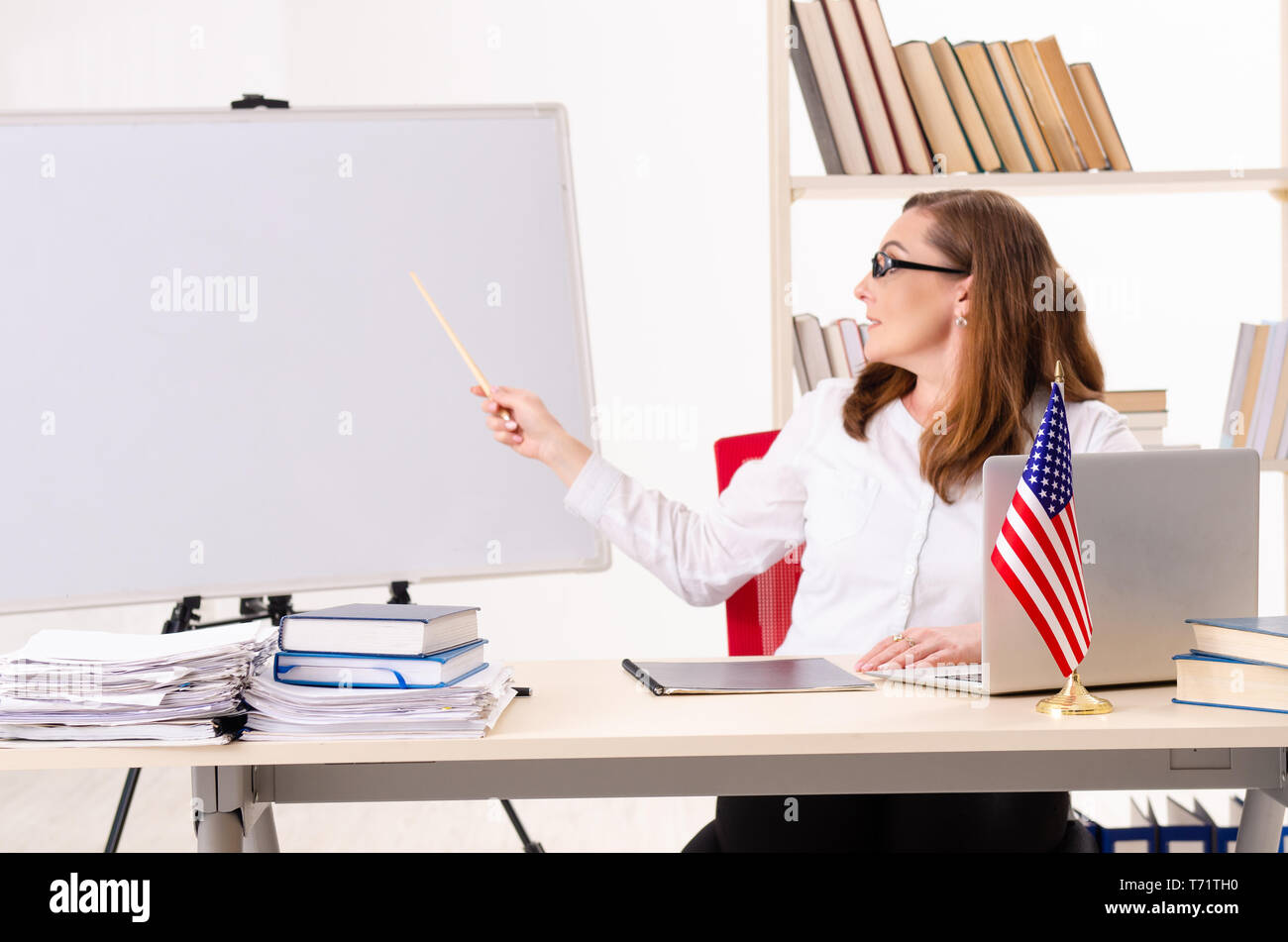 Female english teacher in the classroom Stock Photo - Alamy