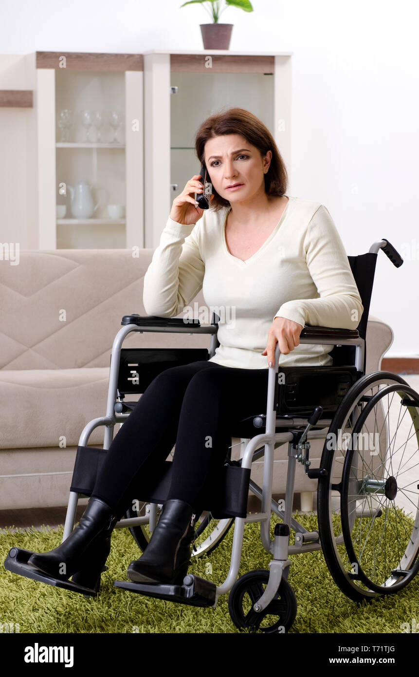 Woman in wheelchair at home Stock Photo - Alamy