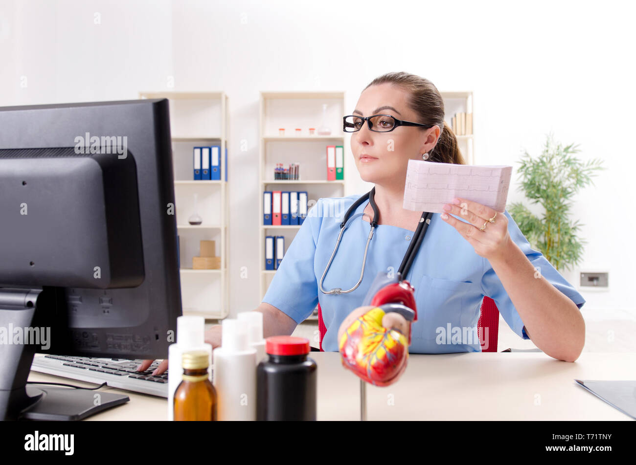 Female doctor cardiologist working in the clinic Stock Photo - Alamy